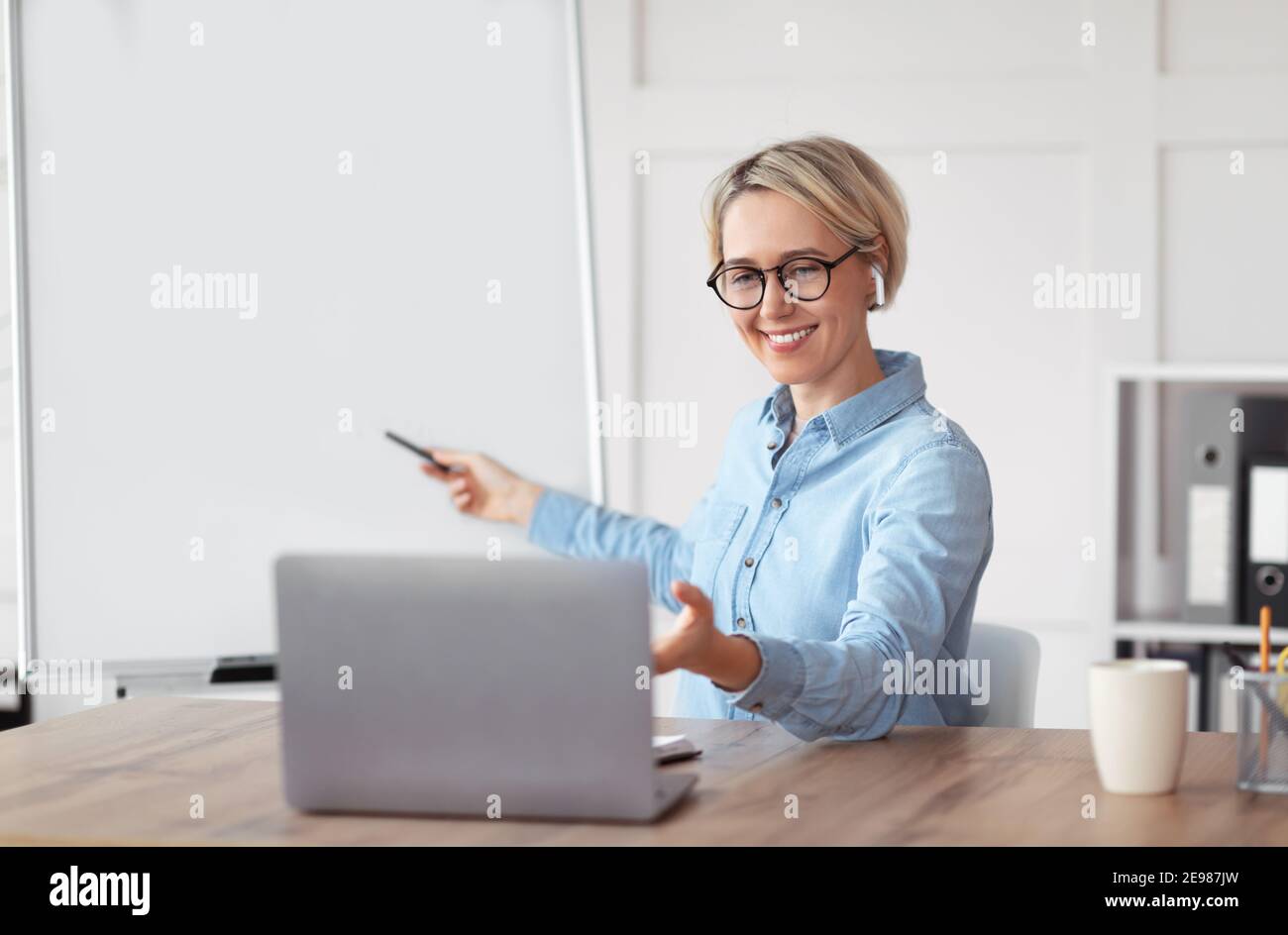 Happy university tutor teaching remote school class, giving online ...