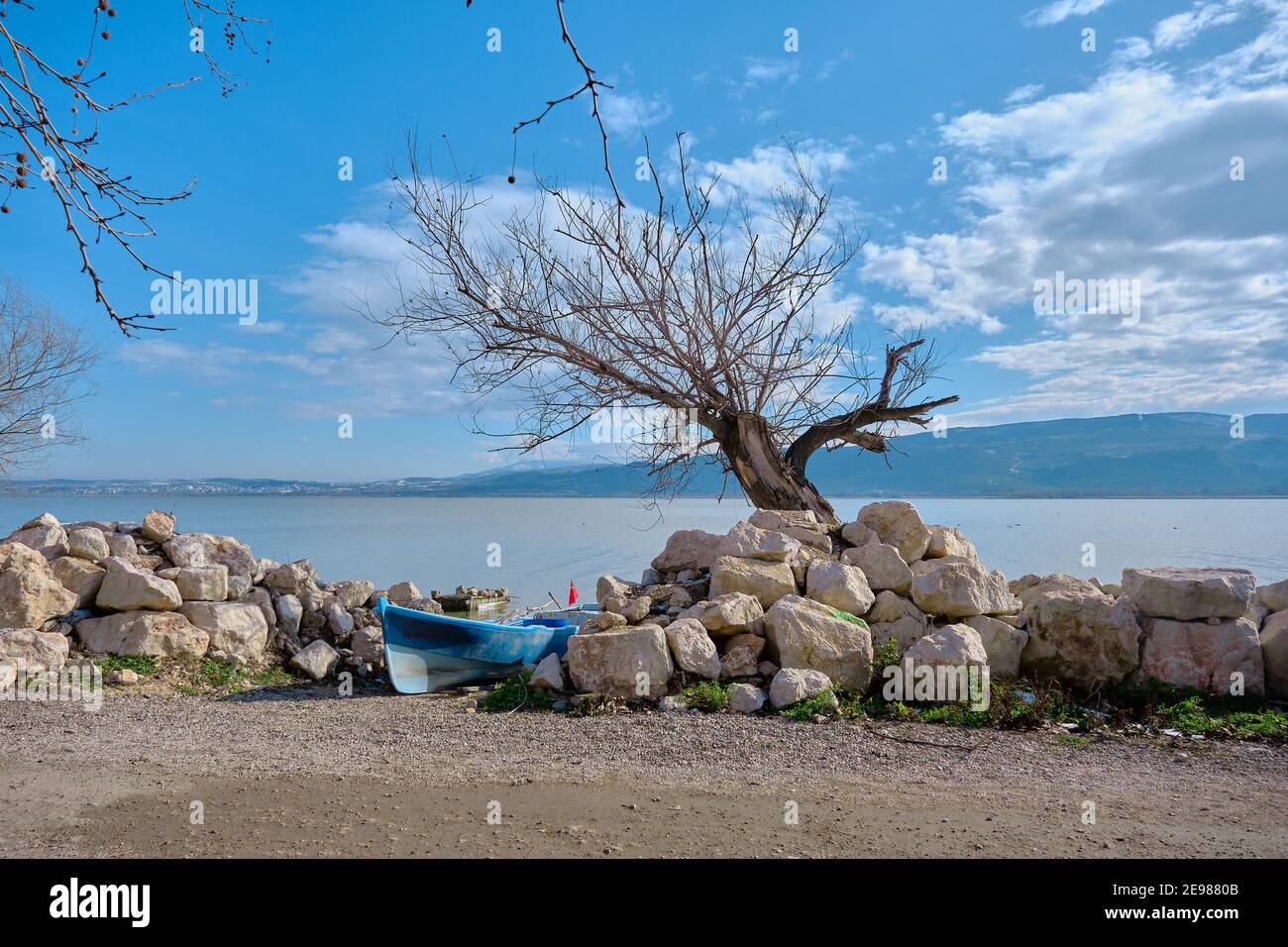 Blue color boats standing on the coast of uluabat lake with huge ...