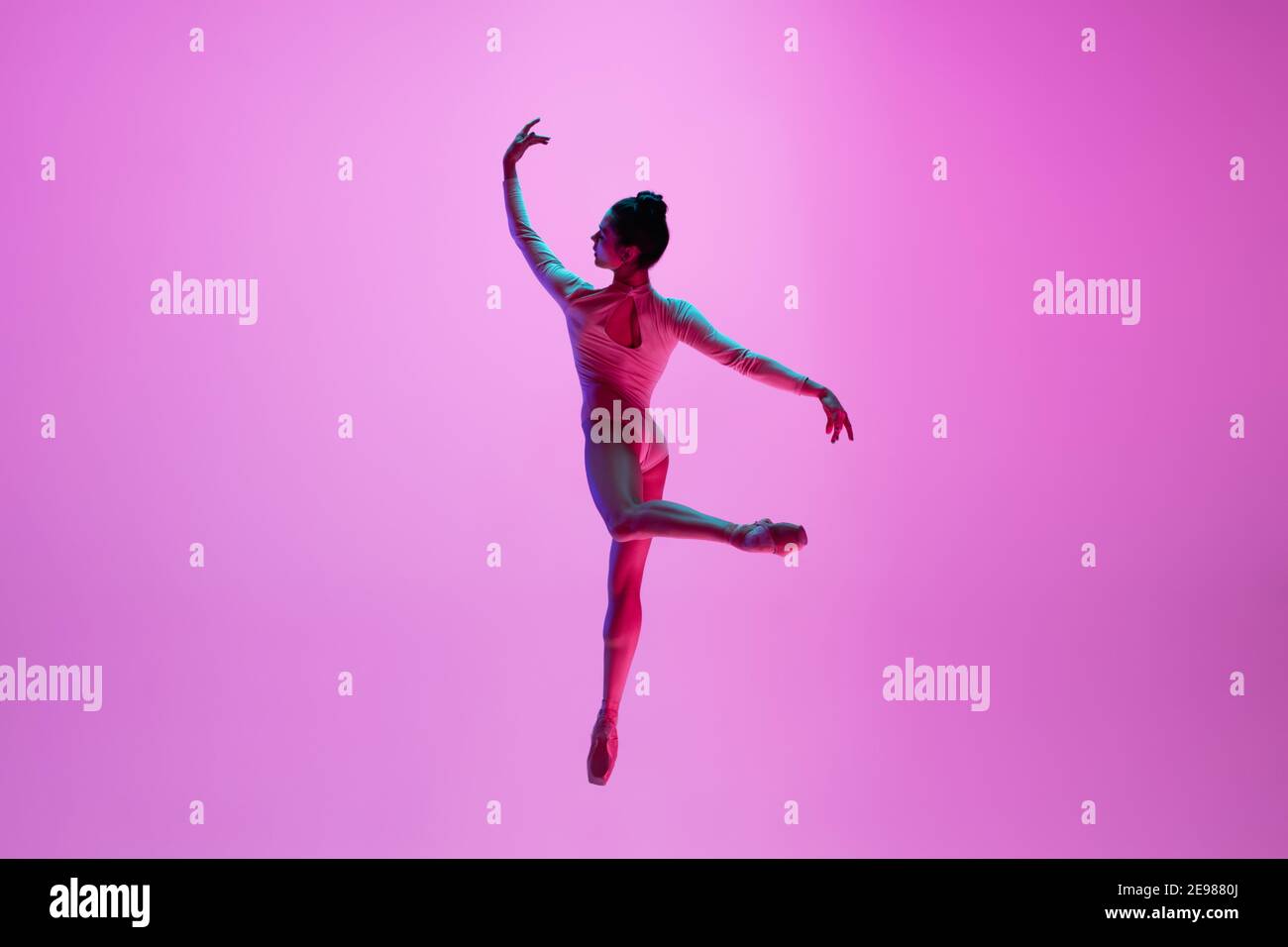 Beautiful. Young and graceful ballet dancer on pink studio background ...