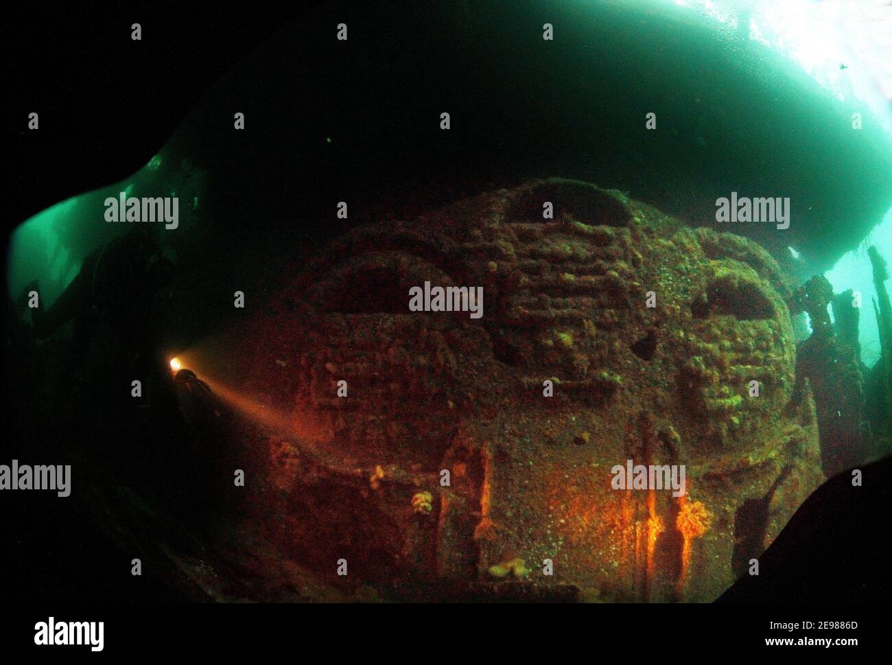 A diver illuminates the boilers of the block ship Tabarka in Burra ...