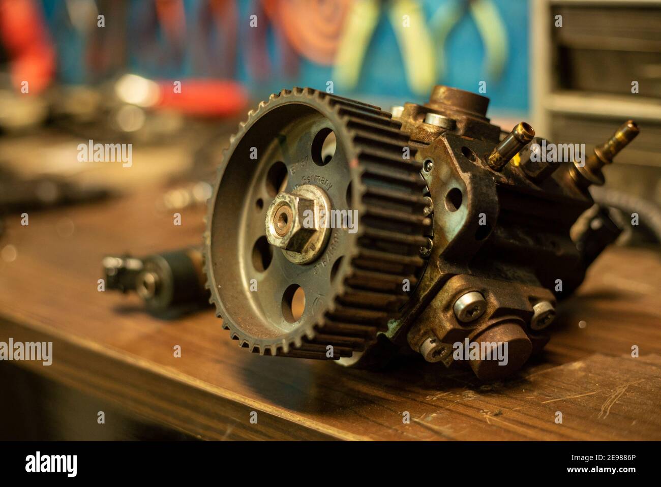 Spare car engine diesel pump resting on the mechanical workshop bench ...