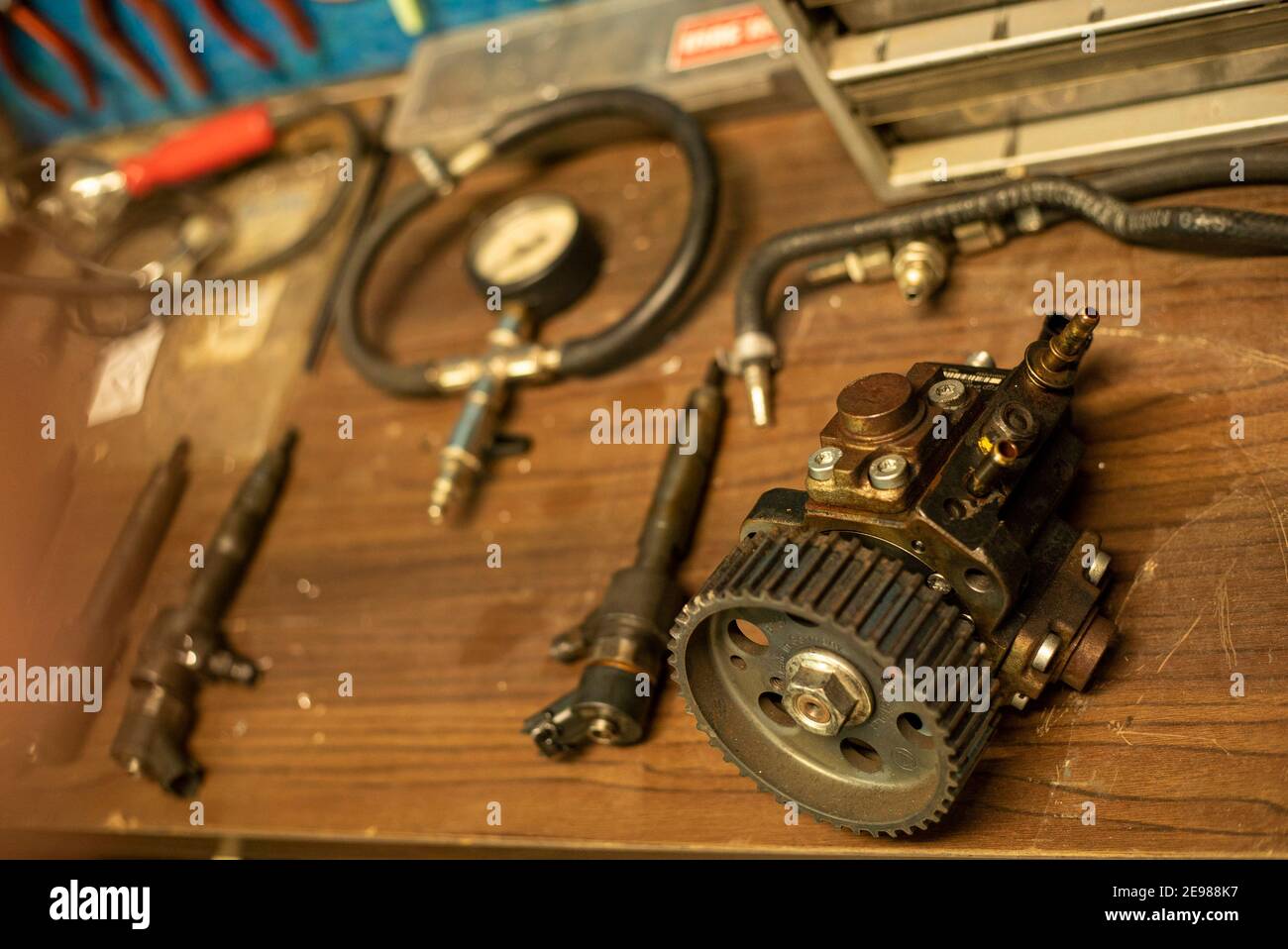 Spare car engine diesel pump resting on the mechanical workshop bench ...