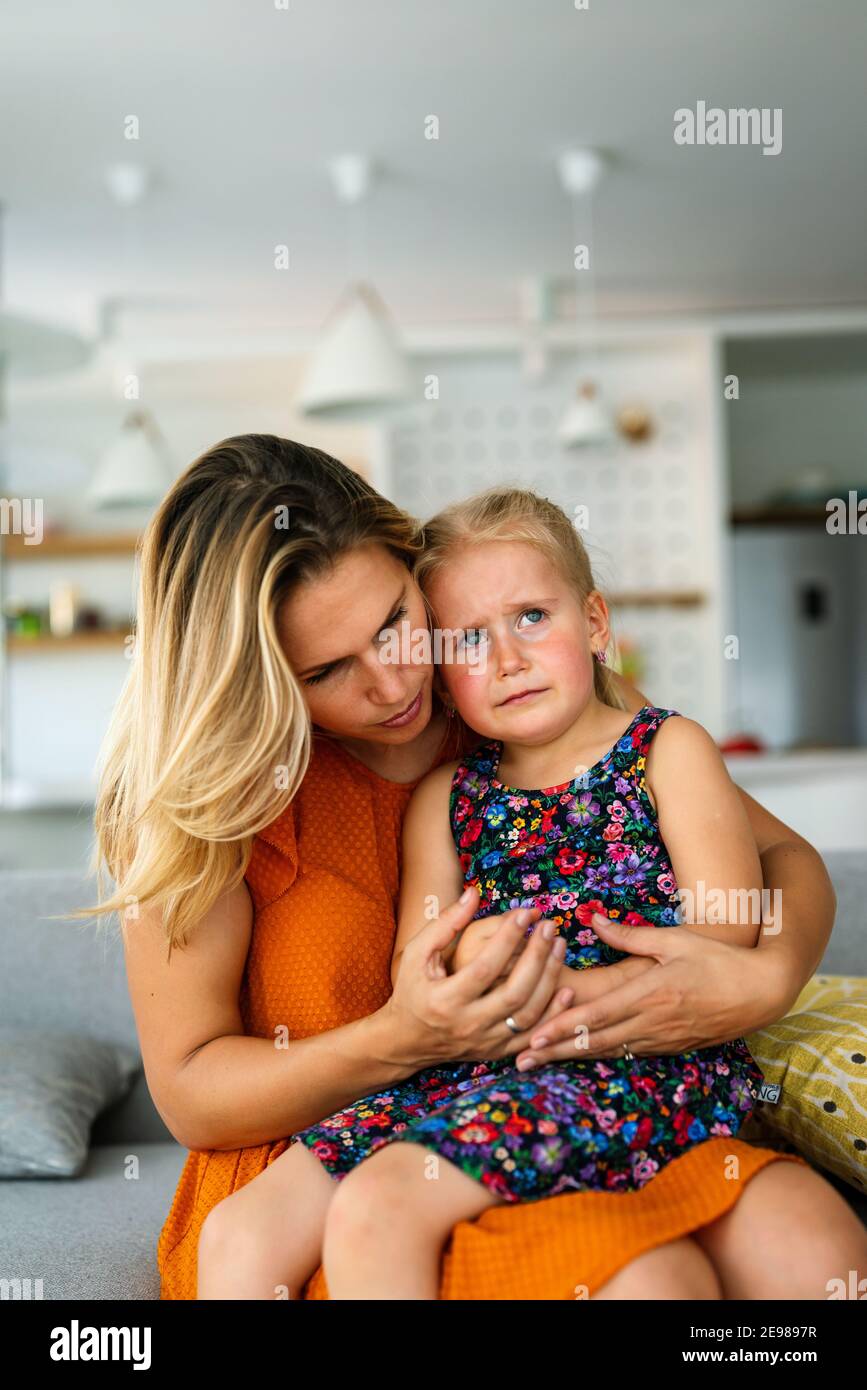 Mother comforting her crying child after she hit her hand Stock Photo ...