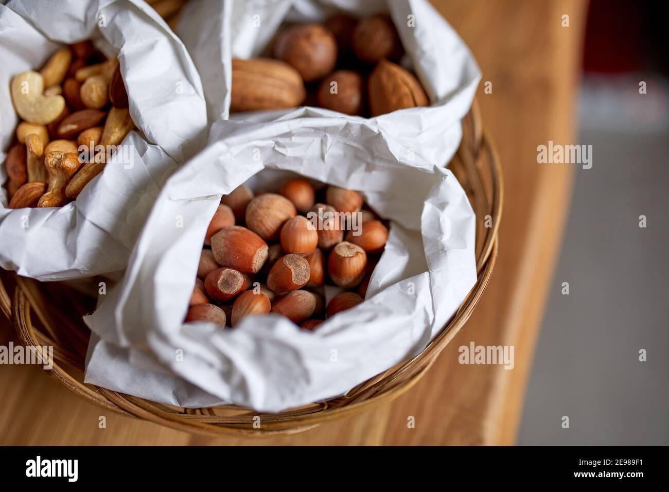 Top view Various sort of nuts on the table in a paper bag on wooden ...