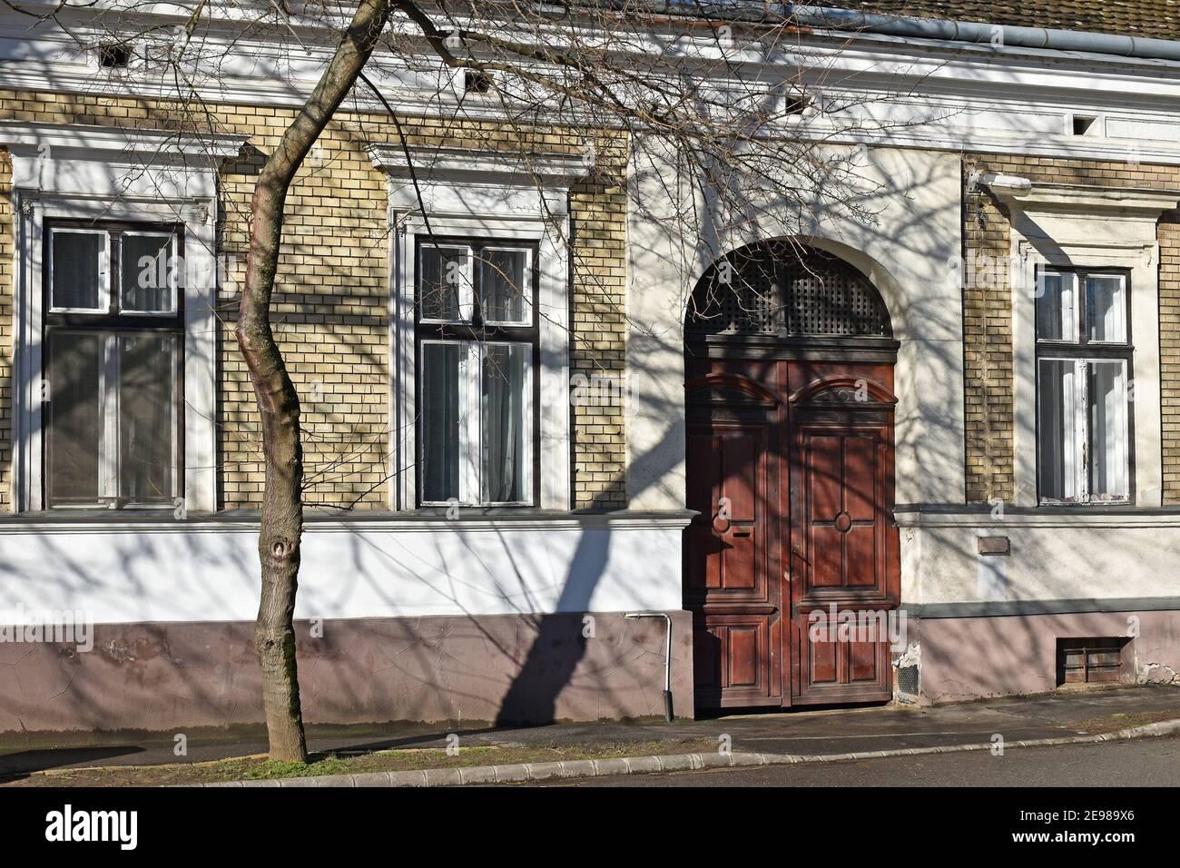 Old house with shadow of a tree in winter time Stock Photo - Alamy