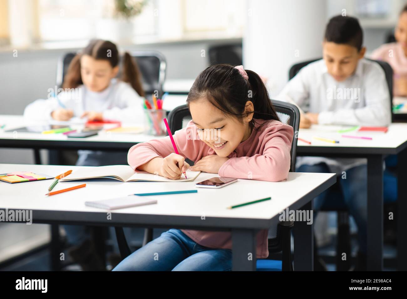 Asian elementary schoolgirl studying in hi-res stock photography and ...