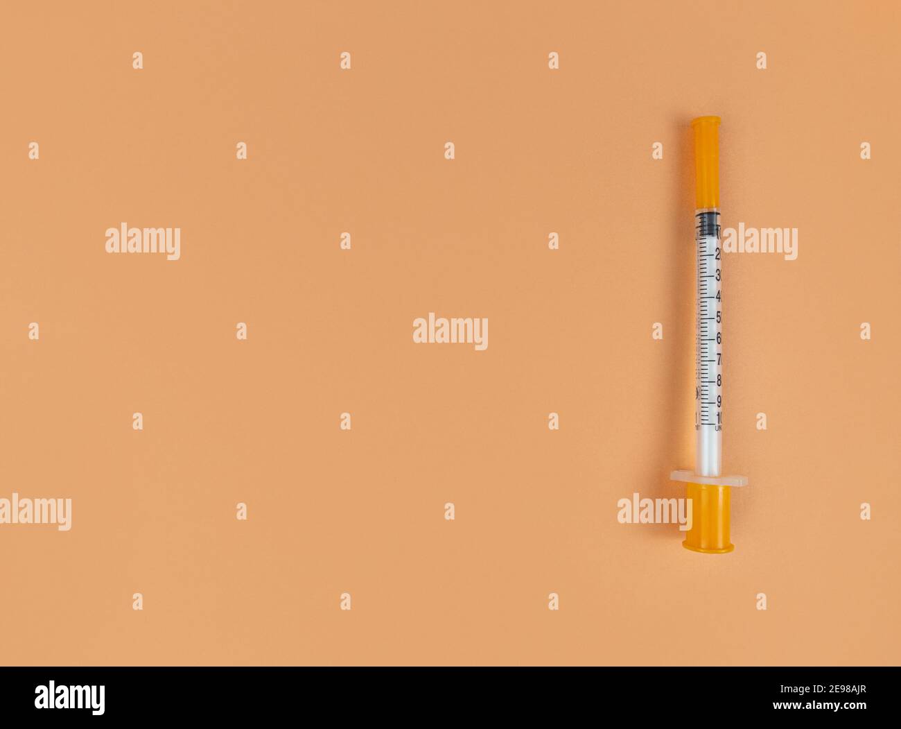 Insulin syringe on orange background with copy space Stock Photo - Alamy