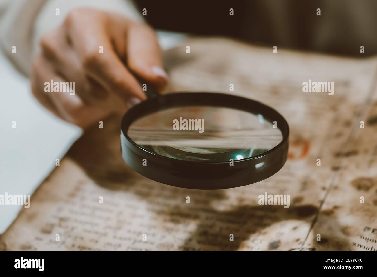 Historian scientist reading antique book with magnifying glass ...