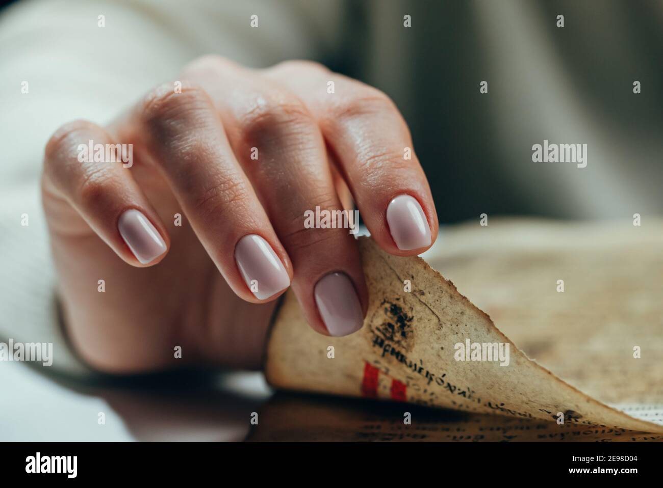 Woman flipping through pages of antique book. Lady with Bible ...