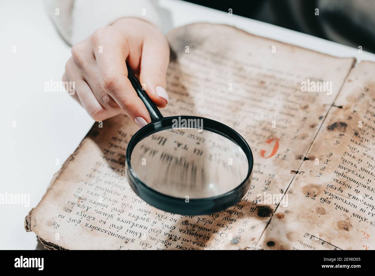 Historian scientist reading antique book with magnifying glass ...
