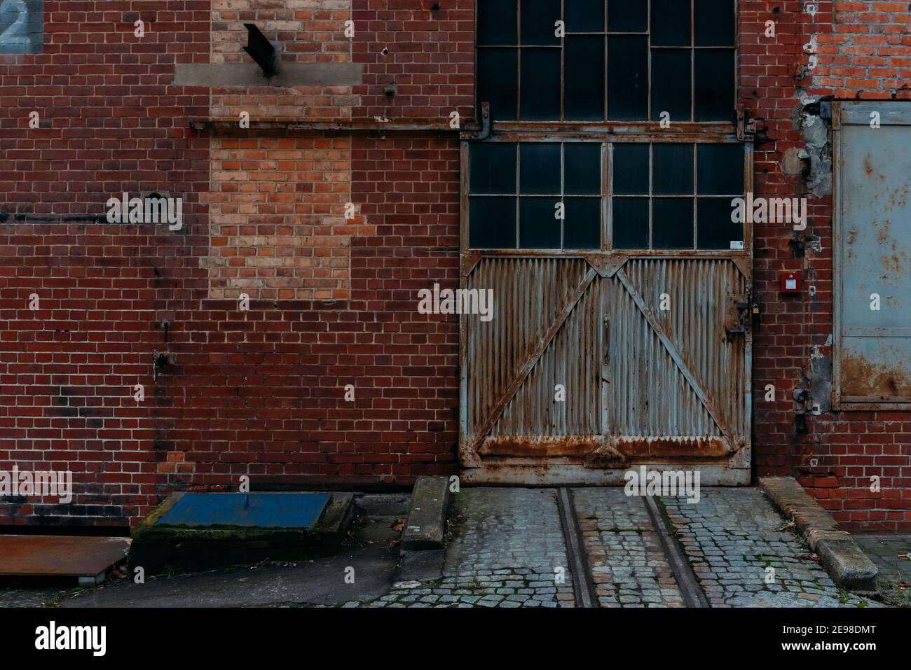 An old rusty gate of an old warehouse, old brick warehouse, brick ...