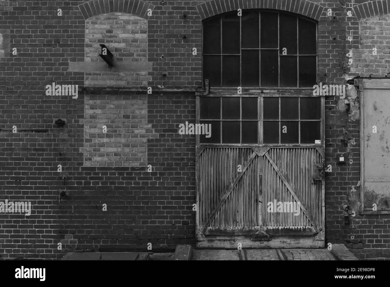 An old rusty gate of an old warehouse, old brick warehouse, brick ...