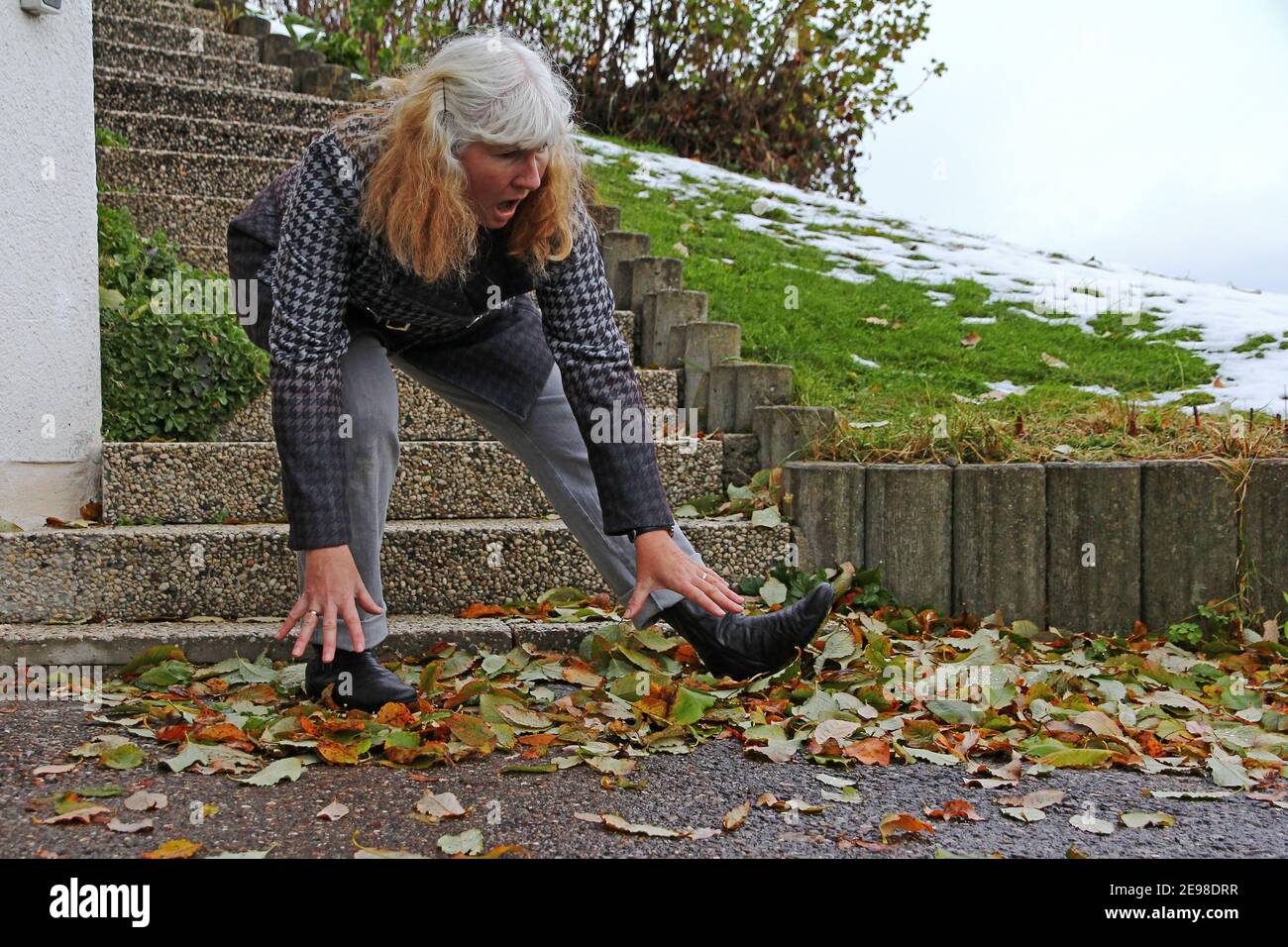 Danger of slipping in autumn and winter. A woman slipped on a wet ...