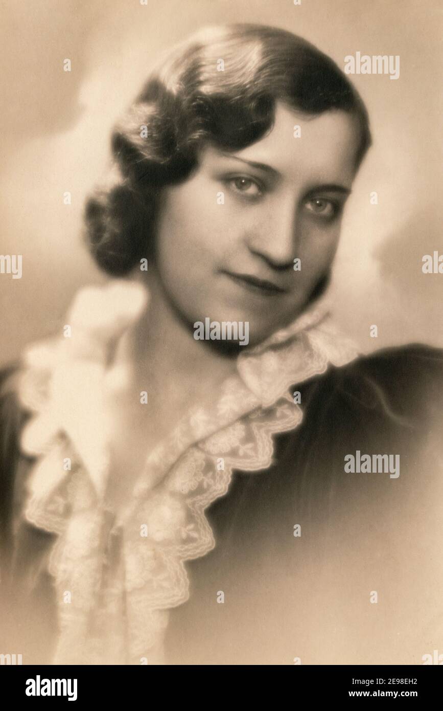 Germany - CIRCA 1920s: Portrait of female sitting at bench in studio ...