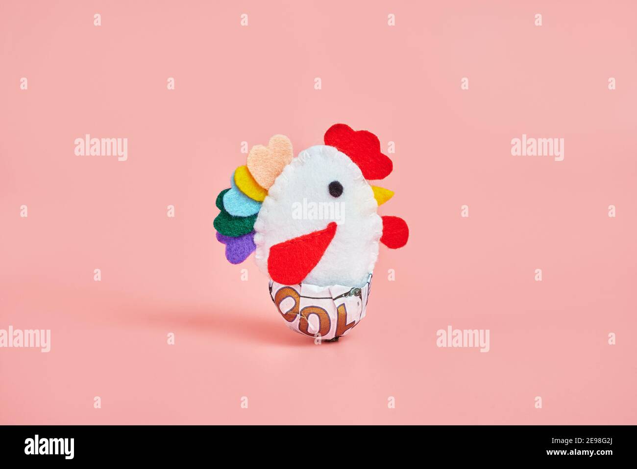 toy chicken and eggshells with 100 dollar bills. concept. pink ...