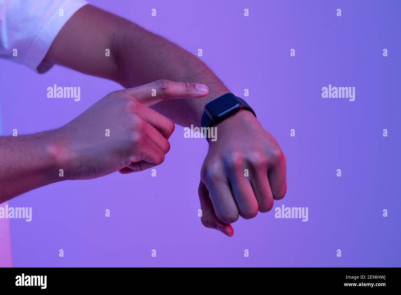 Smart devices. African man pressing button on smart watch with black ...