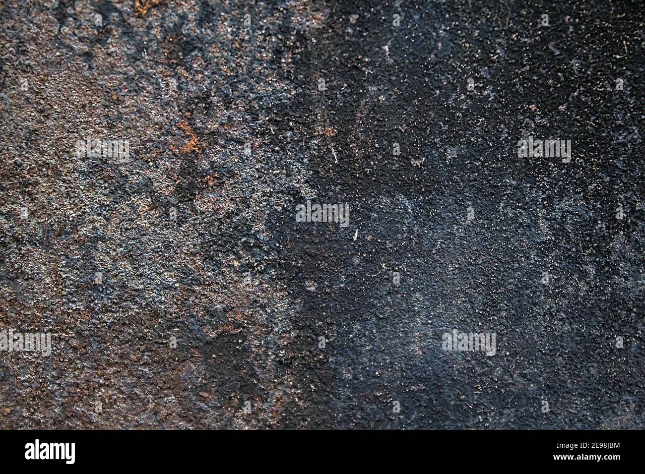 It's an old, rusty, dark-colored metal surface. Abstract background ...