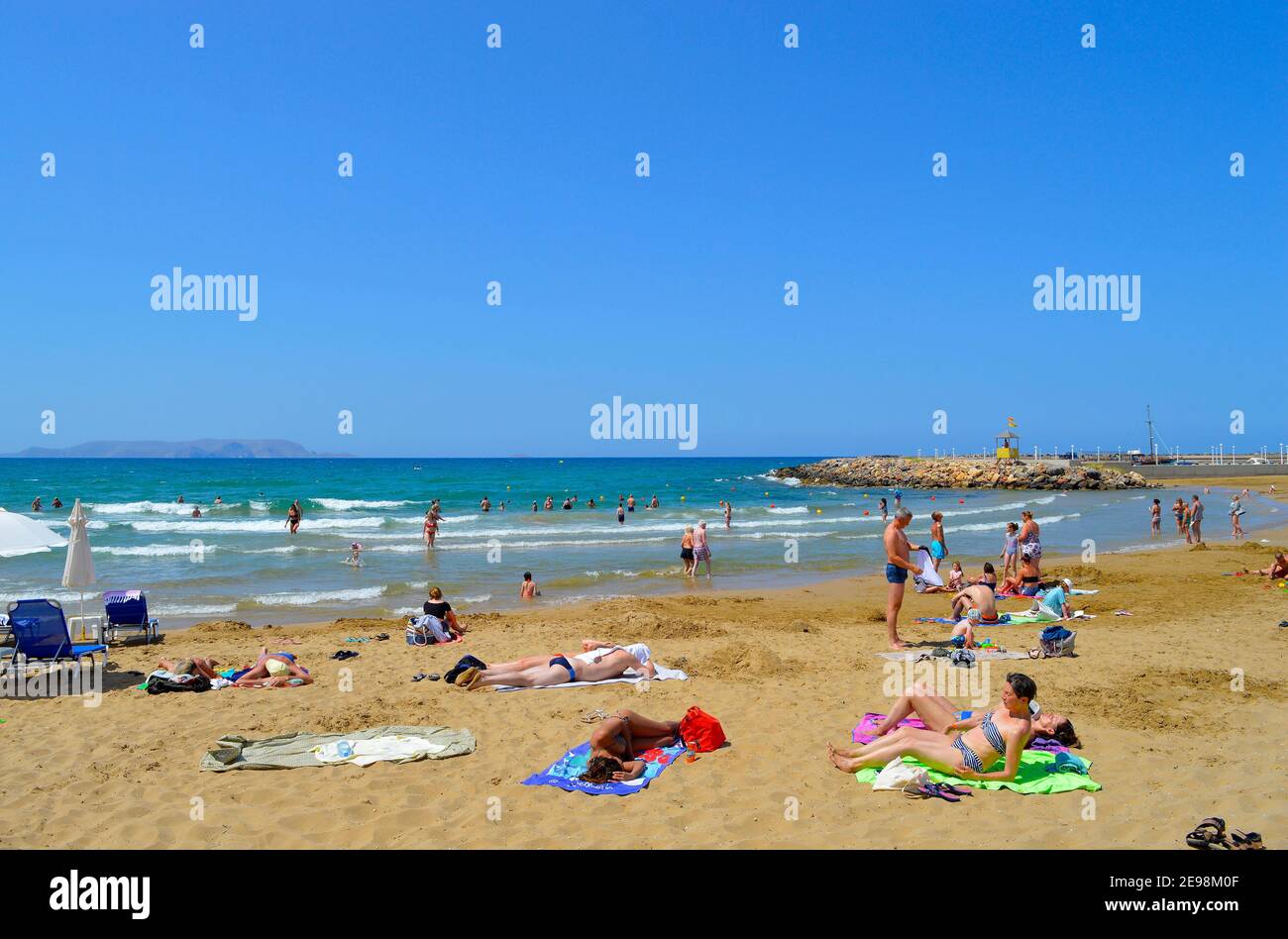 Tourists sunbathing on Gouves beach in Crete the largest and most ...