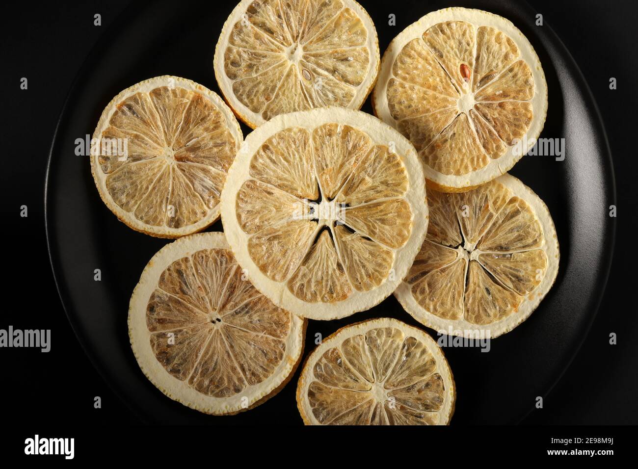 Dried lemon slices in a black plate Stock Photo - Alamy