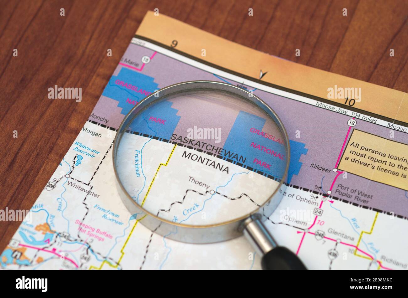 magnifying lens on map showing Montana (USA) and Saskatchewan (Canada ...