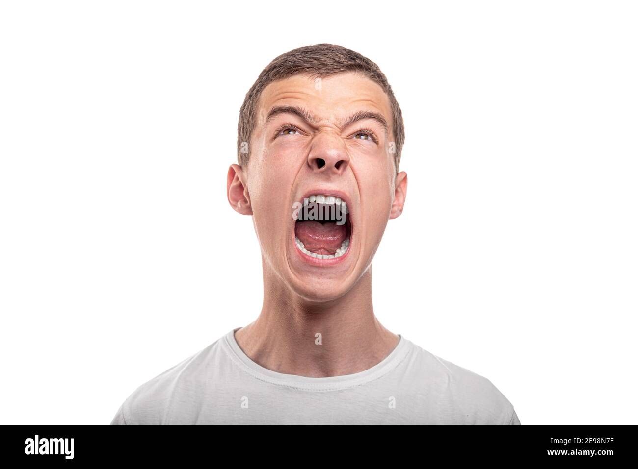 The young man shouts. Isolated on white background. Scream Stock Photo ...