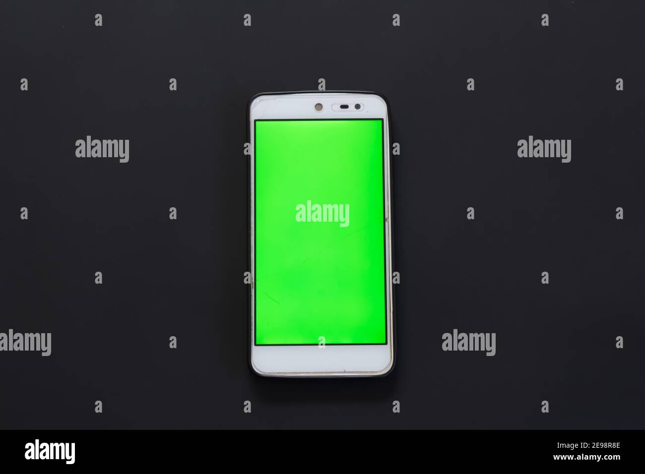 Smartphone with green screen on black background Stock Photo - Alamy