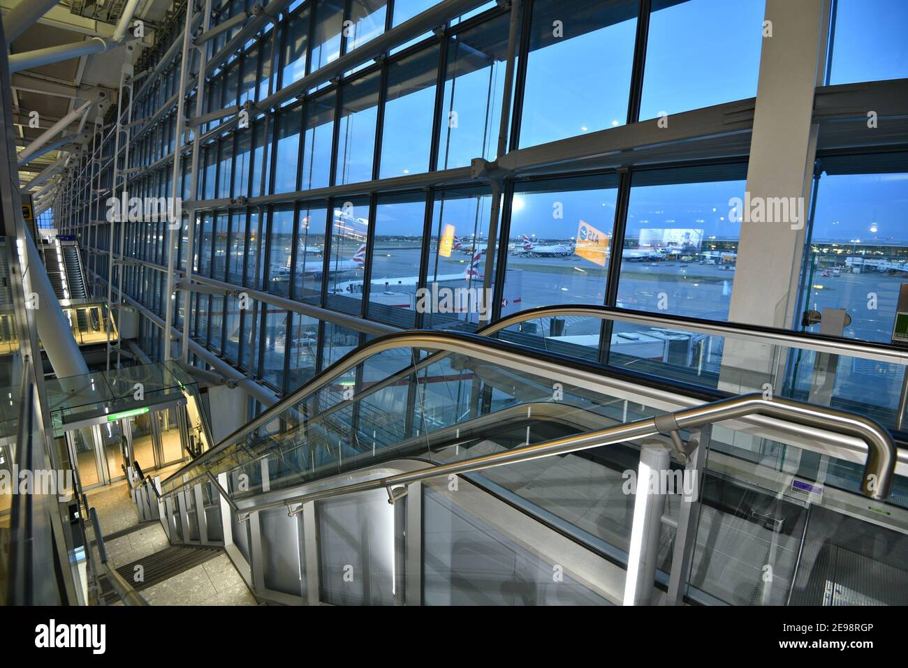 Escalator and side windows overlooking the runways at Heathrow ...