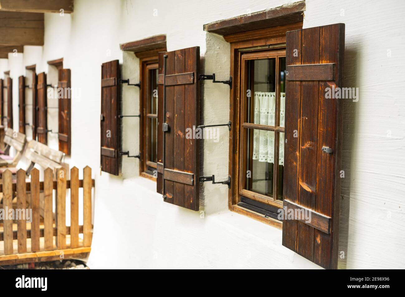 Windows and shutters alpine style in a row Stock Photo - Alamy