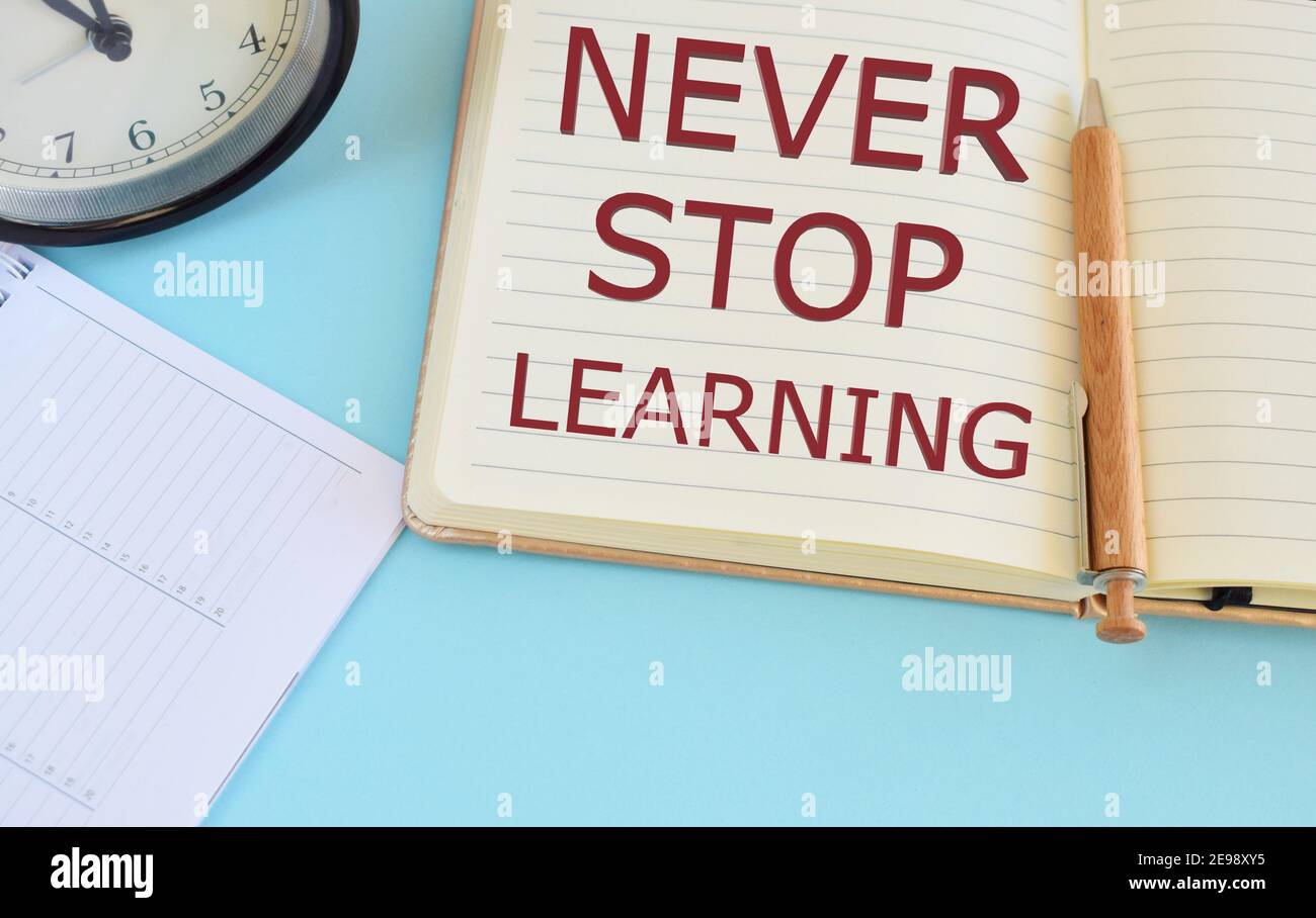 Never stop learning text written in Notebook. Learning concept Stock ...