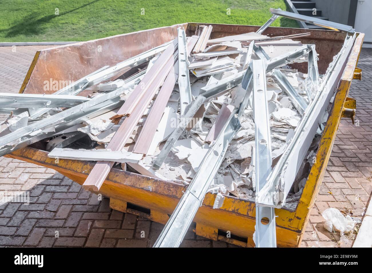 Construction garbage cart full of cement, and remains of construction ...