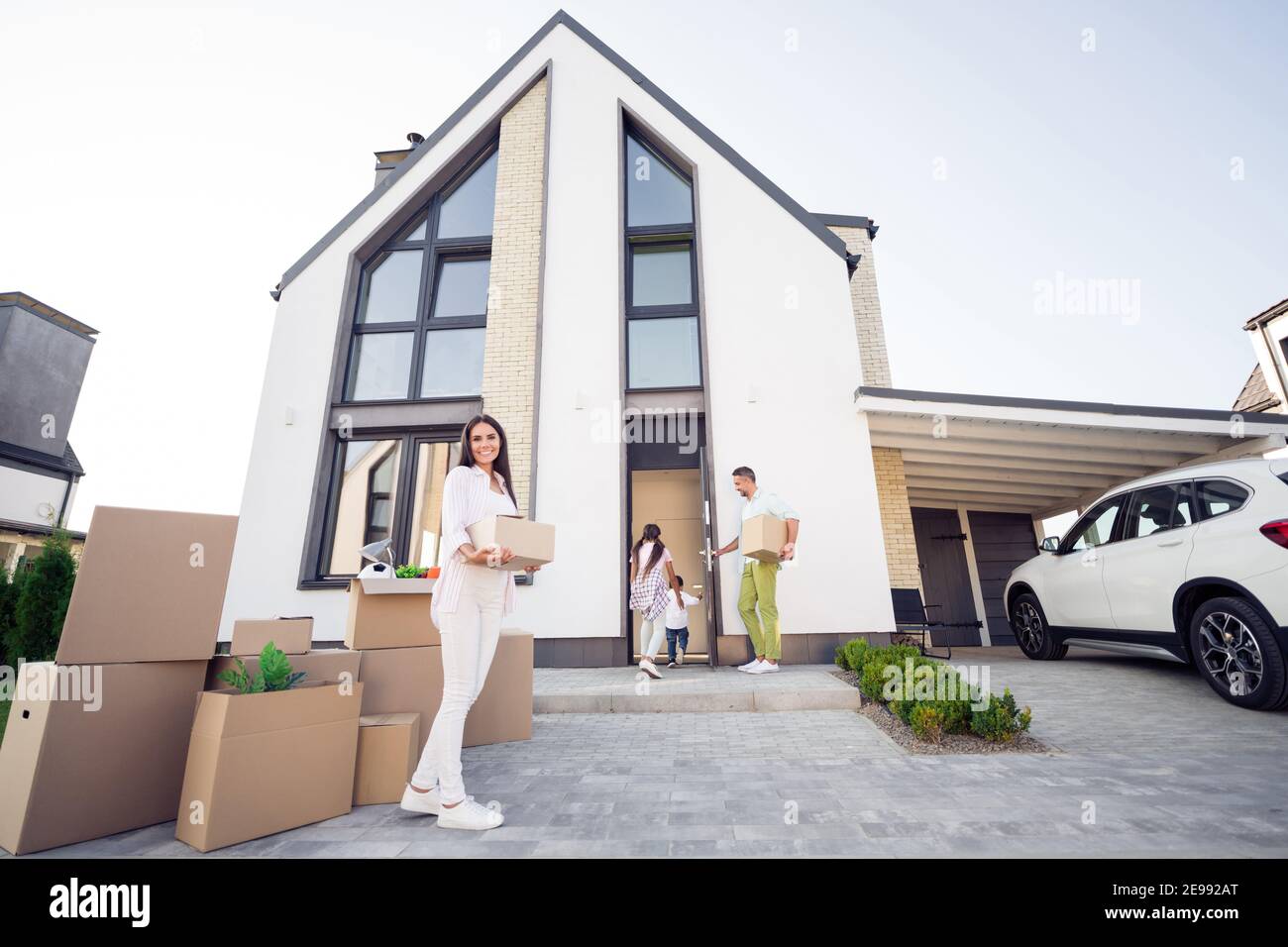 View from bellow of big family with little careless kids relocating ...