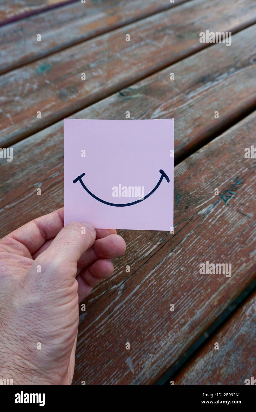 hand with a smile note on paper Stock Photo - Alamy