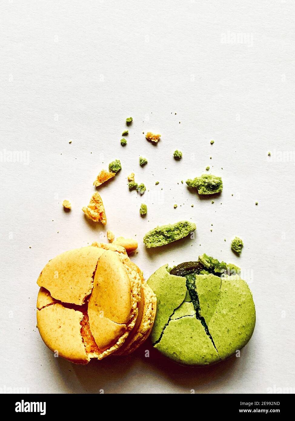 Yellow and green broken macarons on the light background Stock Photo ...