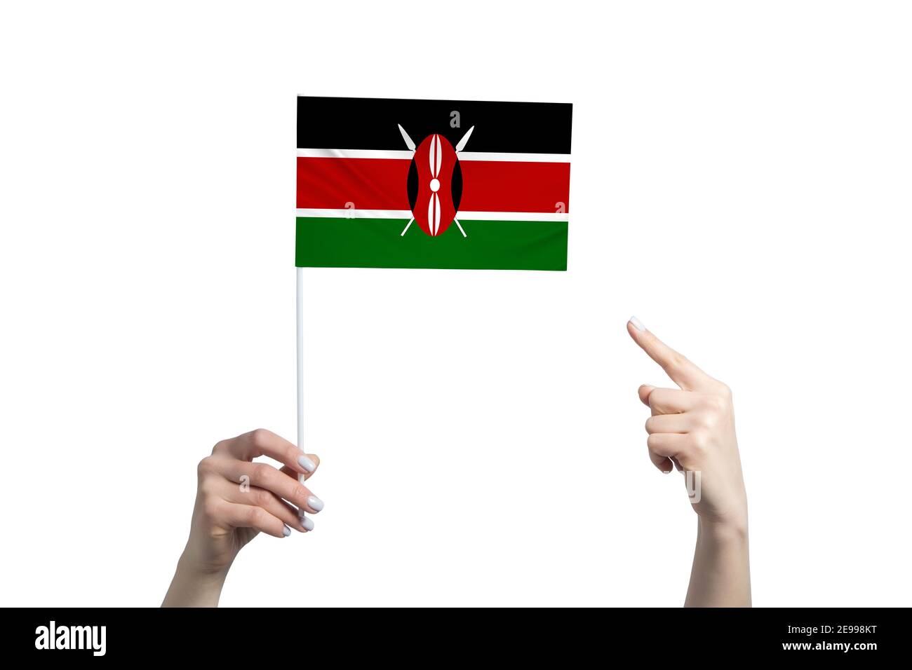 A beautiful female hand holds a Kenya flag to which she shows the ...