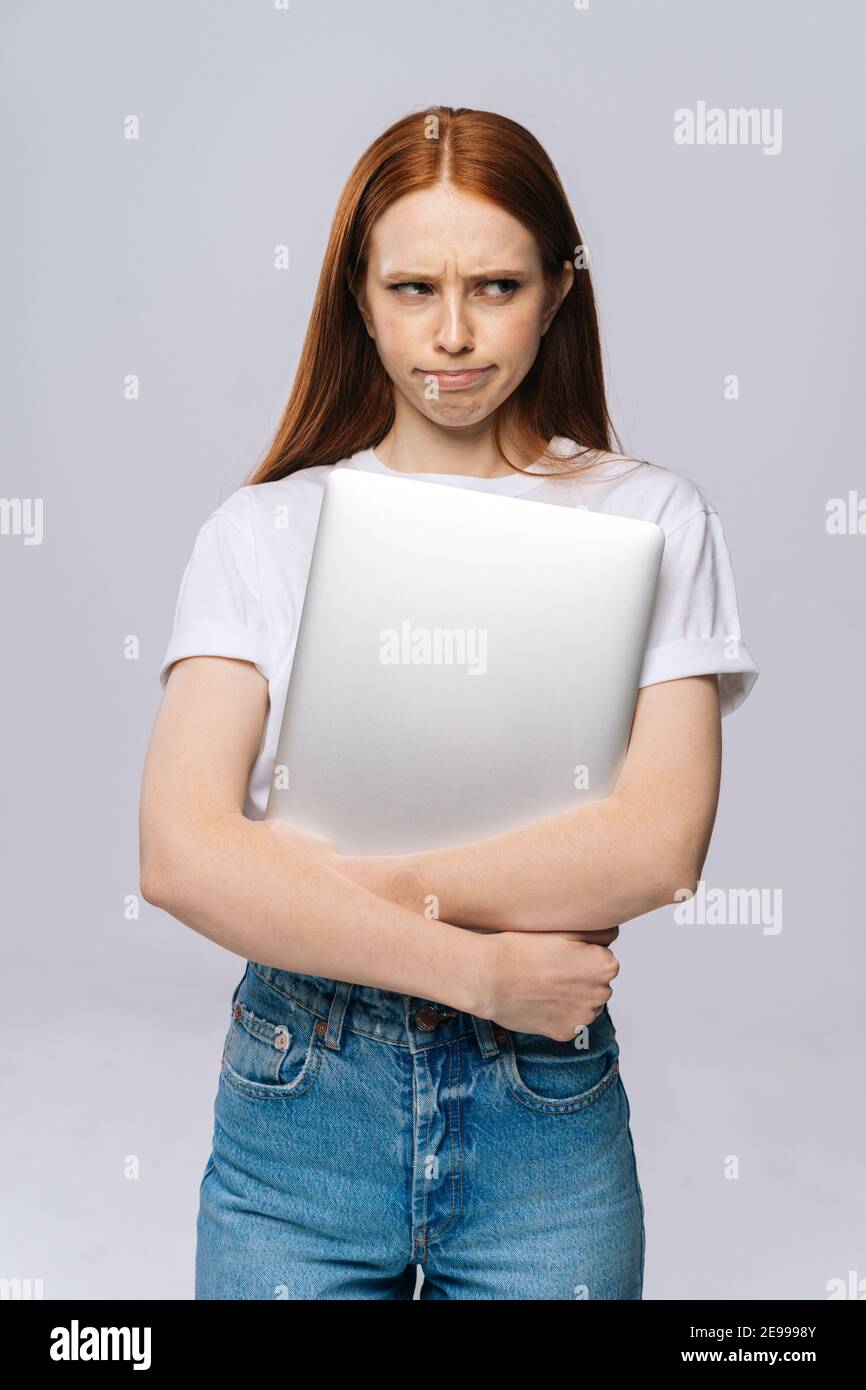 Frustrated upset young business woman or student holding laptop ...