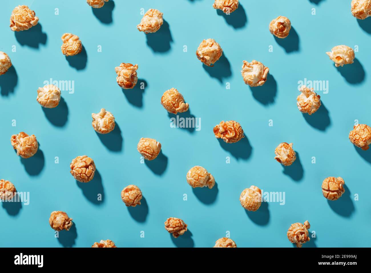 A pattern of popcorn patterns on a blue background. Full screen as a ...