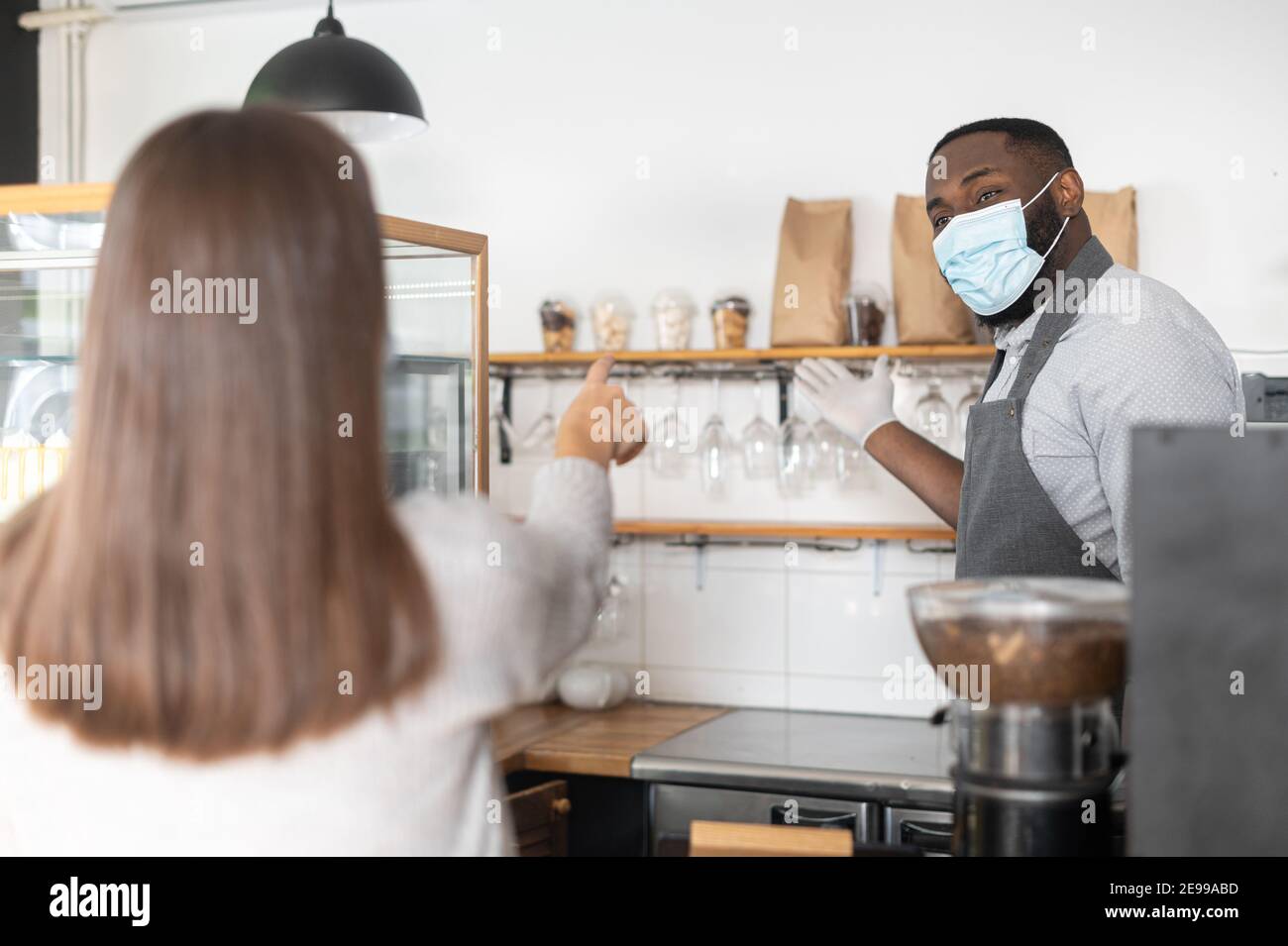 An African American Male Waiter Cafe Owner Wearing Mask And Gloves