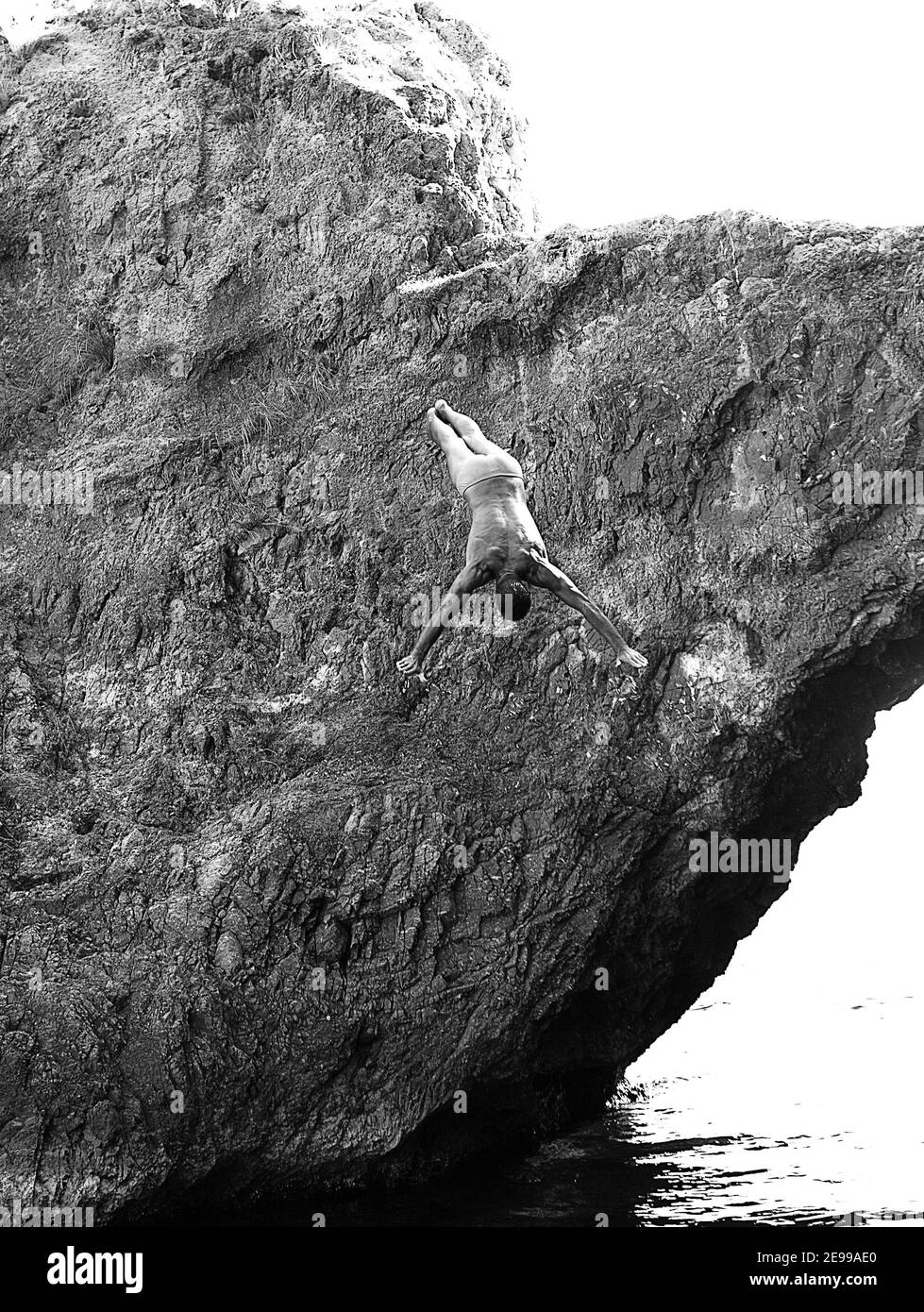 Man dives from a rock into the sea Stock Photo - Alamy