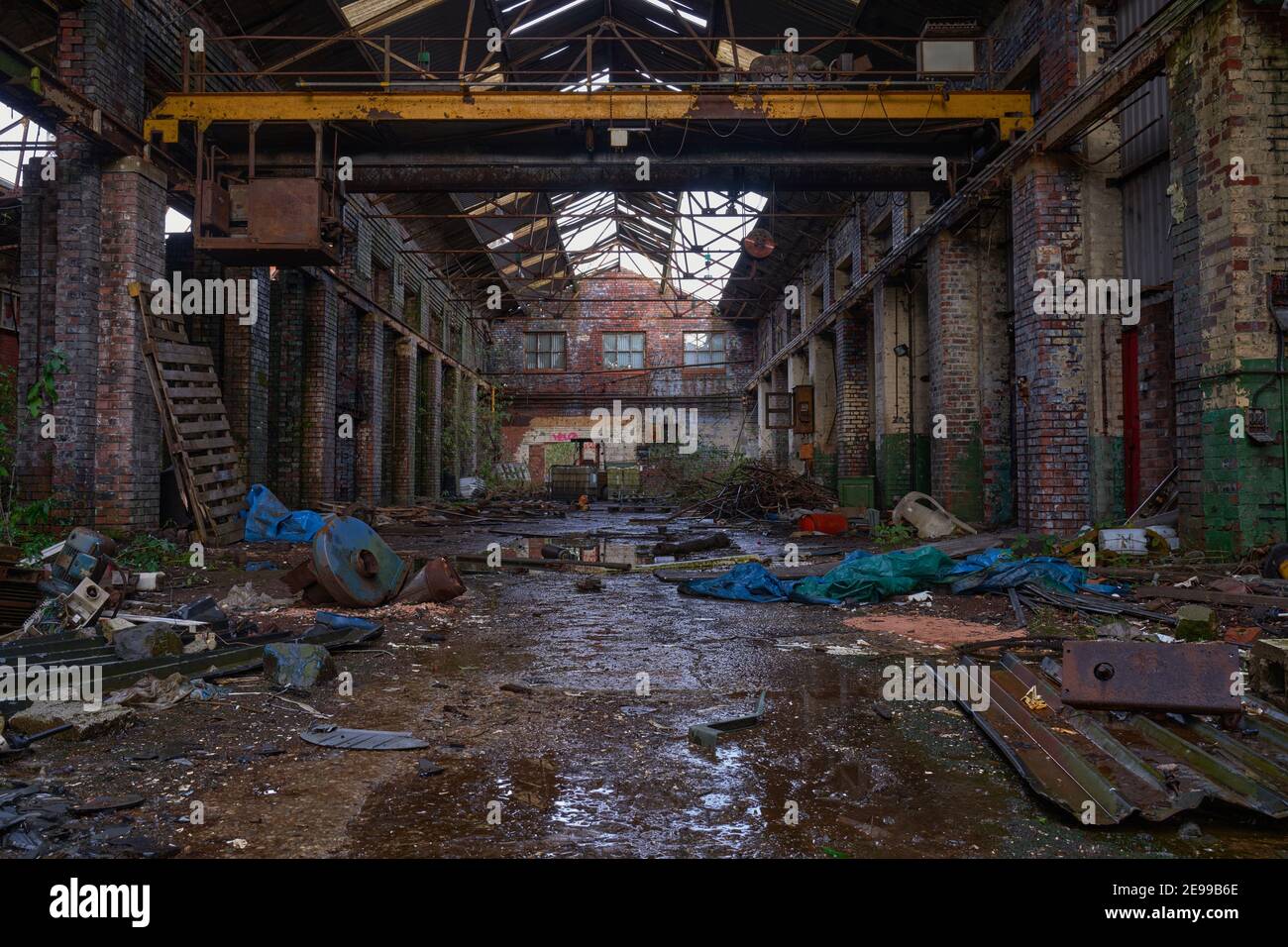 Old factory warehouse abandoned and falling down, the overhead crane is ...