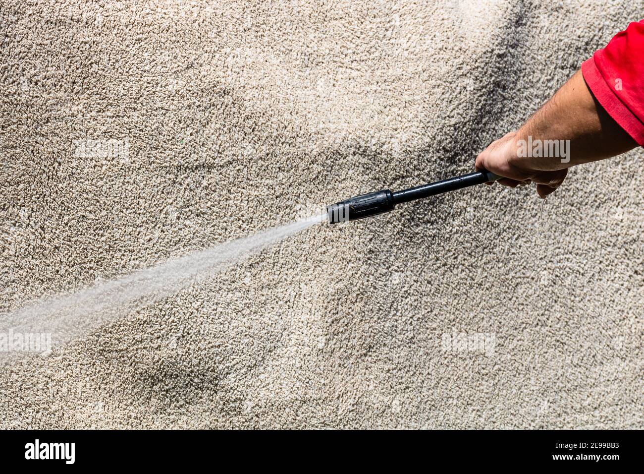 Close up of washing carpets with high pressure washer. Cleaning the ...