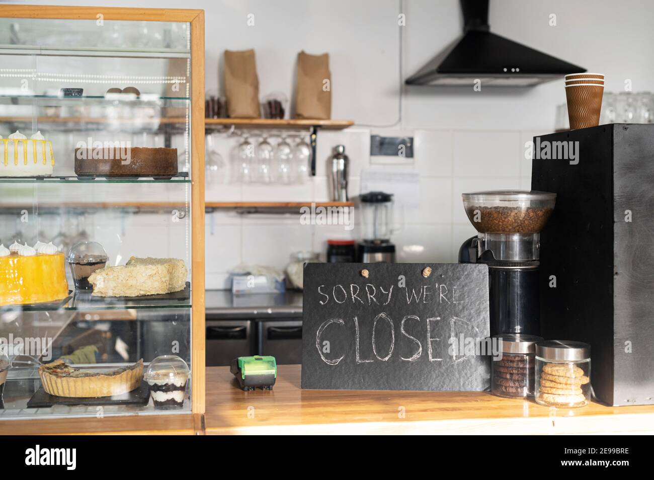 Closed sign board on the bar counter in an empty coffee shop. Cafe, bar ...