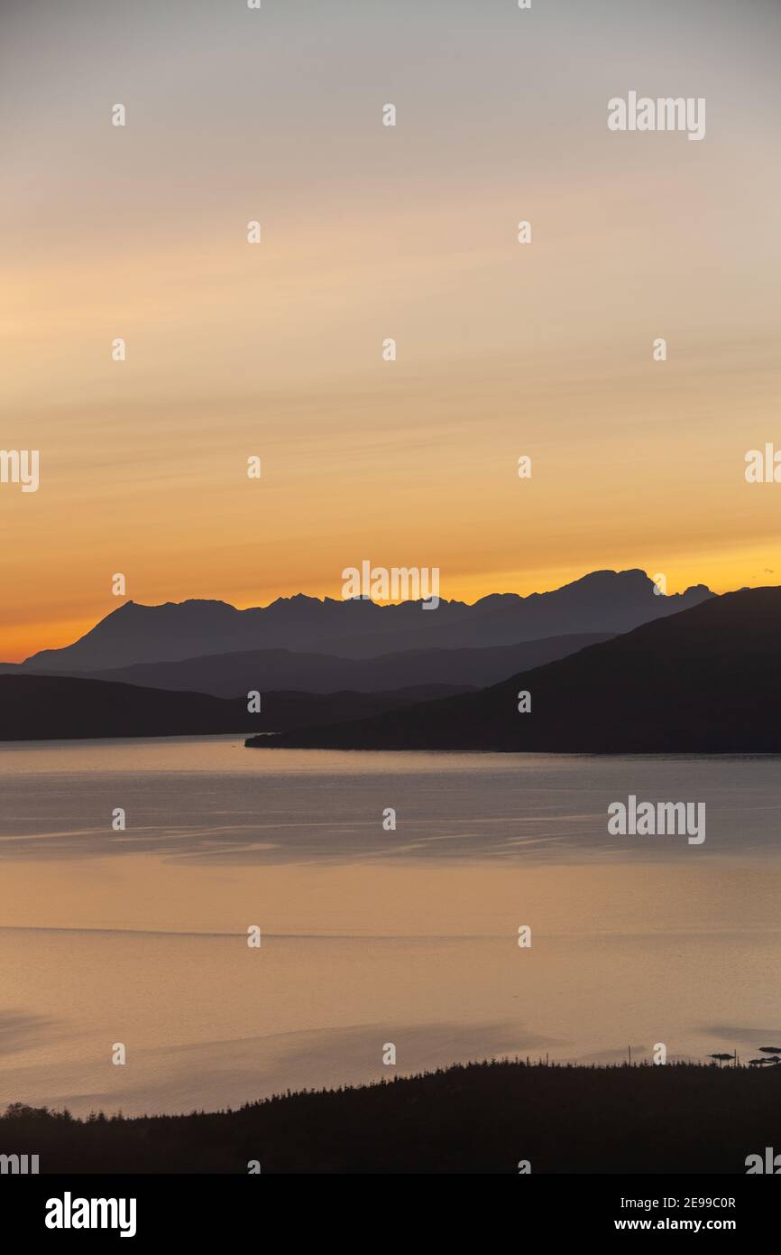 A beautiful sunset behind the Skye ridge seen from Arnisdale Stock ...