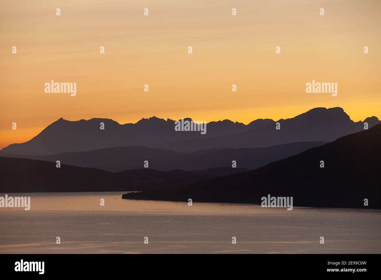 A beautiful sunset behind the Skye ridge seen from Arnisdale Stock ...