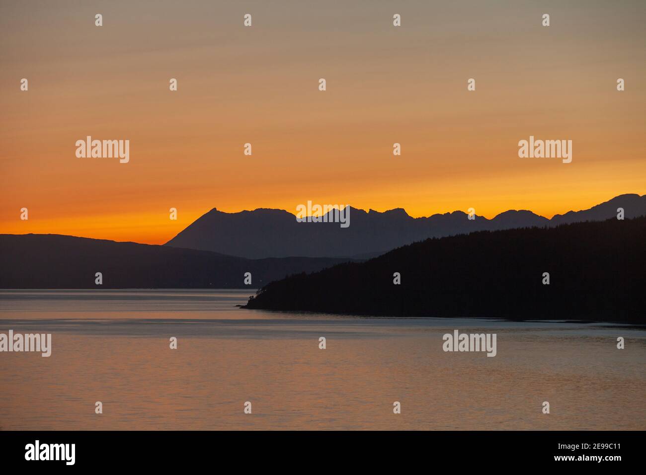 A beautiful sunset behind the Skye ridge seen from Arnisdale Stock ...