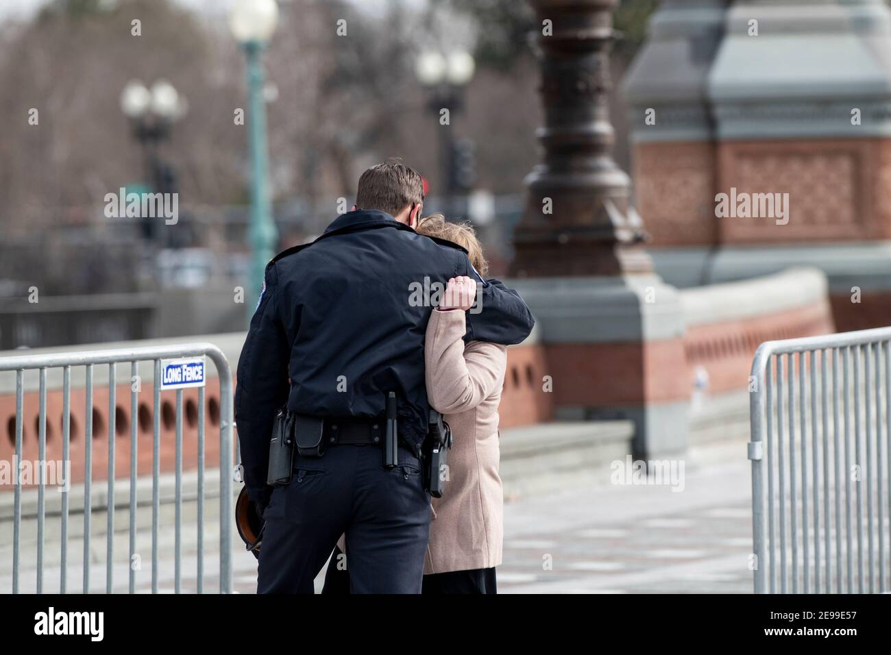 U.S. Capitol police officer John Hersch and his wife Adina comfort each ...