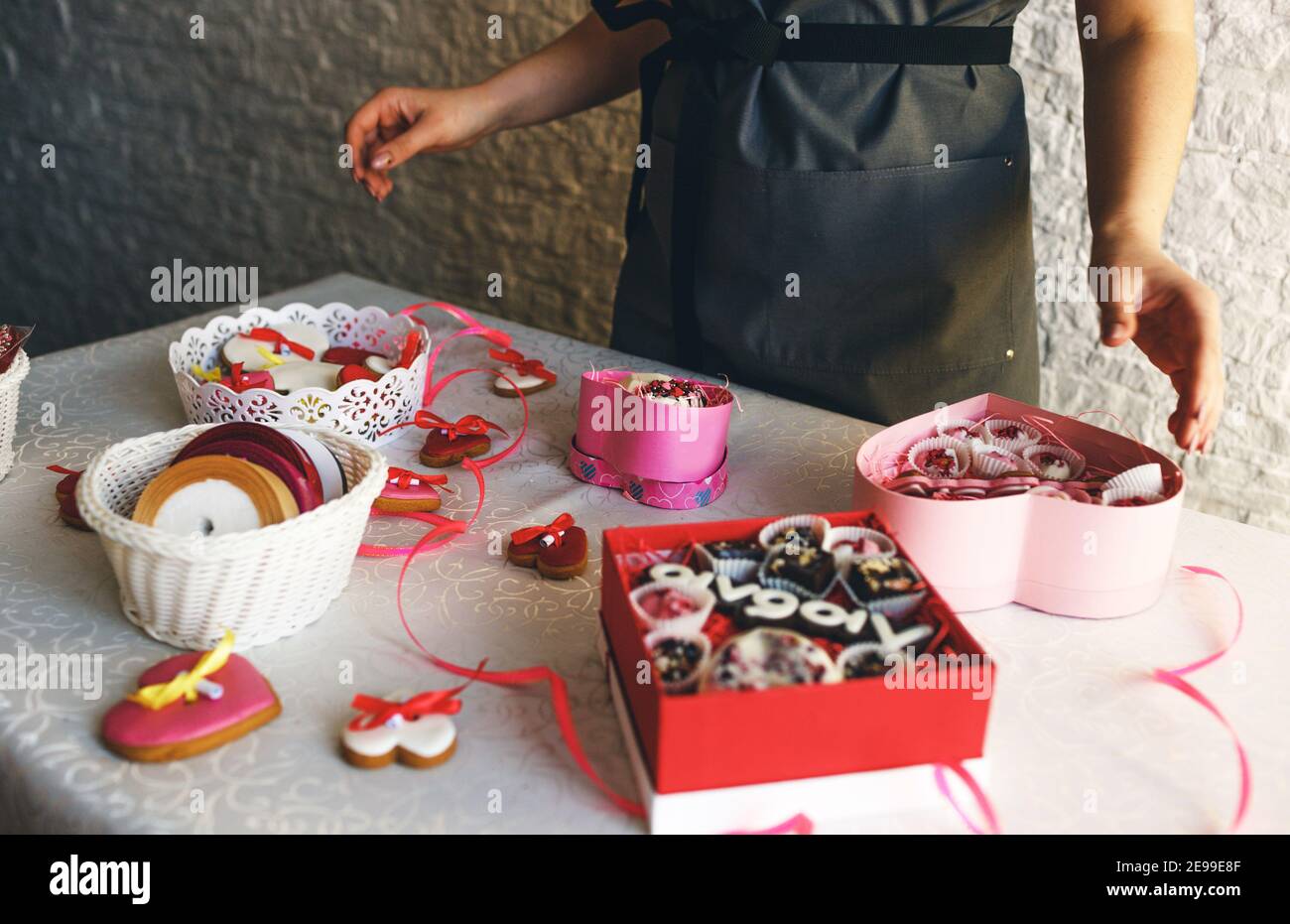 the girl packs the cakes in gift boxes. Preparing for the celebration ...