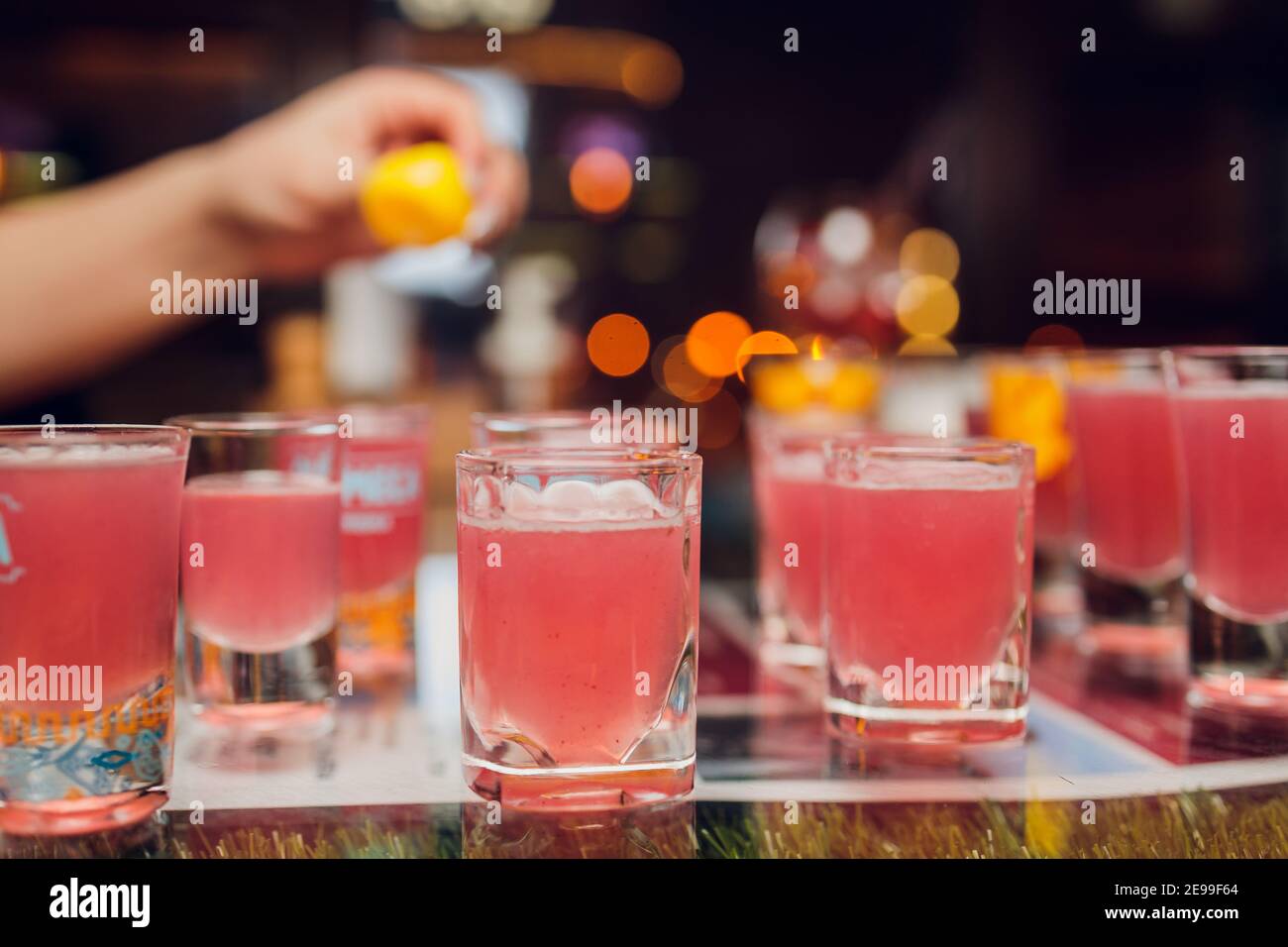 Variation of hard alcoholic shots served on bar counter. Blur bottles ...