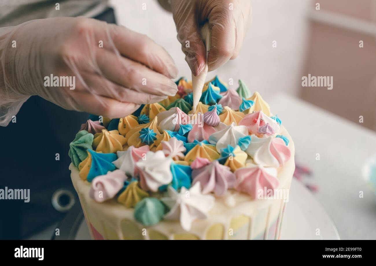 A pastry chef makes a wedding cake with her own hands and puts colorful ...