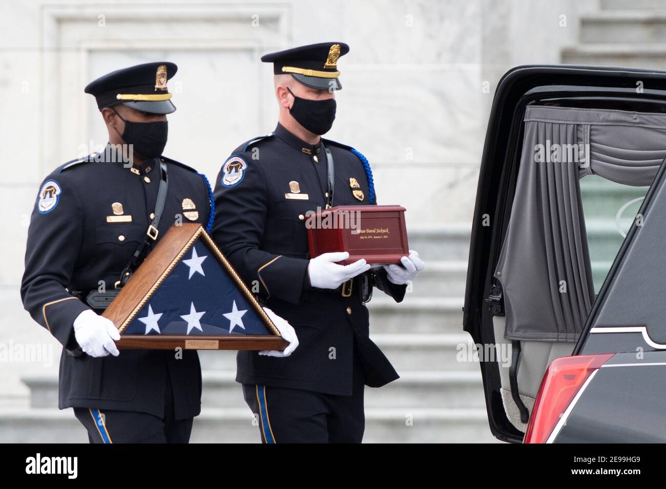 An honor guard carries an urn with the cremated remains of U.S. Capitol ...