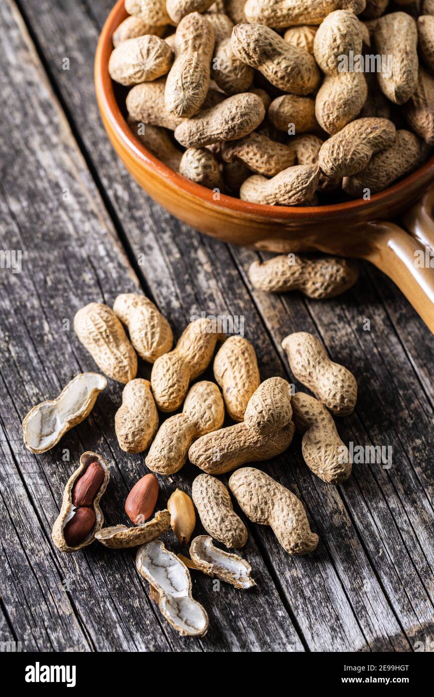 Roasted peanuts. Tasty groundnuts on wooden table Stock Photo - Alamy